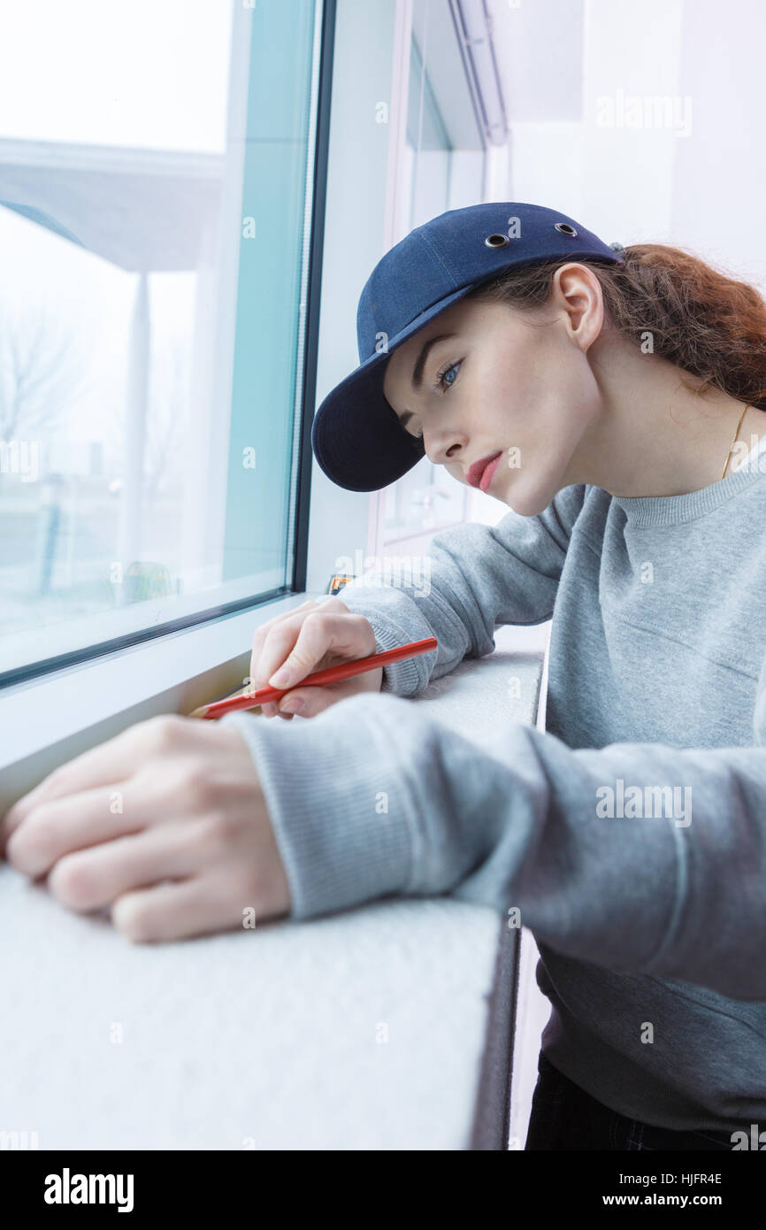 female window fitter Stock Photo - Alamy