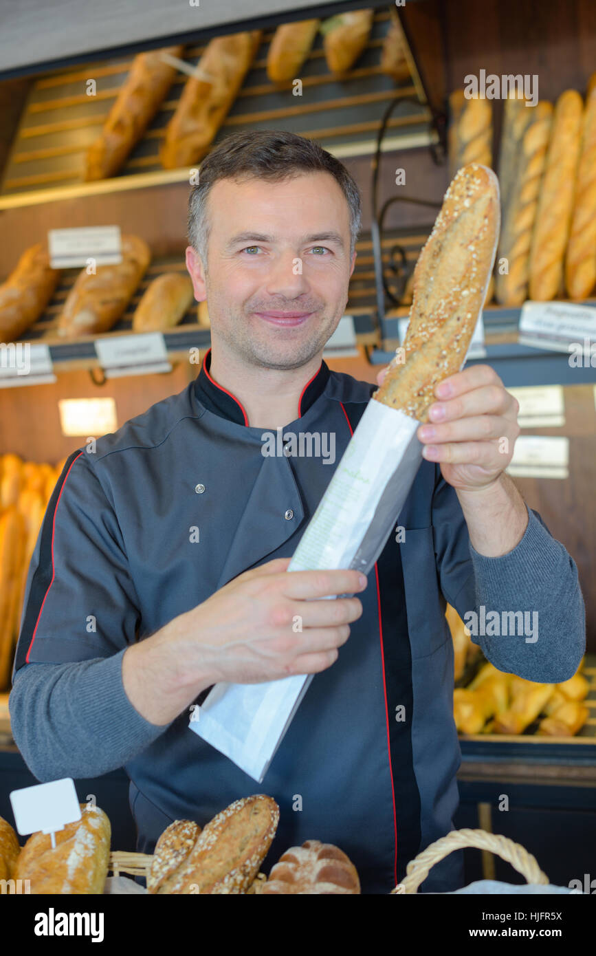 bakery shopkeeper is proud of his bread production Stock Photo - Alamy