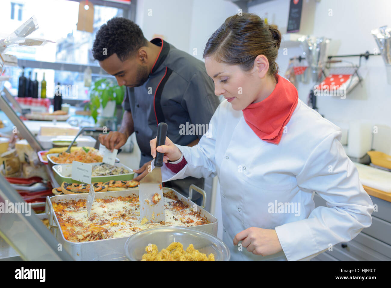 Lady serving food Stock Photo - Alamy
