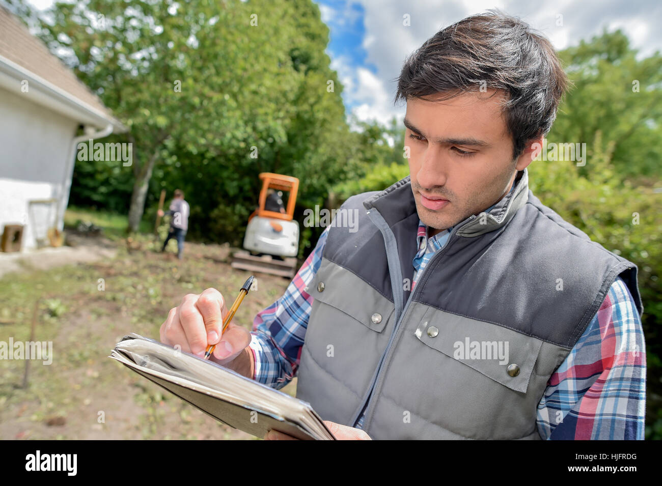 Foreman holding paper and pen Stock Photo - Alamy