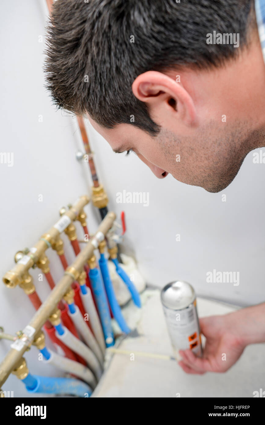 Plumber repairing central piping system Stock Photo - Alamy
