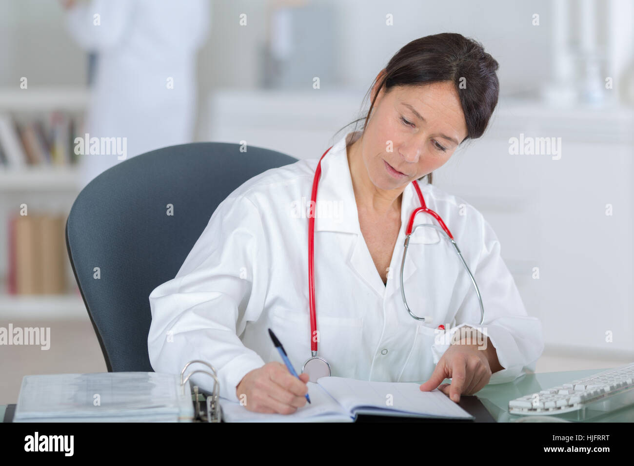 portrait of a beautiful female doctor working in her office Stock Photo ...