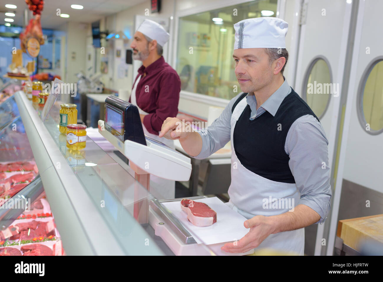 Butcher serving steak Stock Photo - Alamy