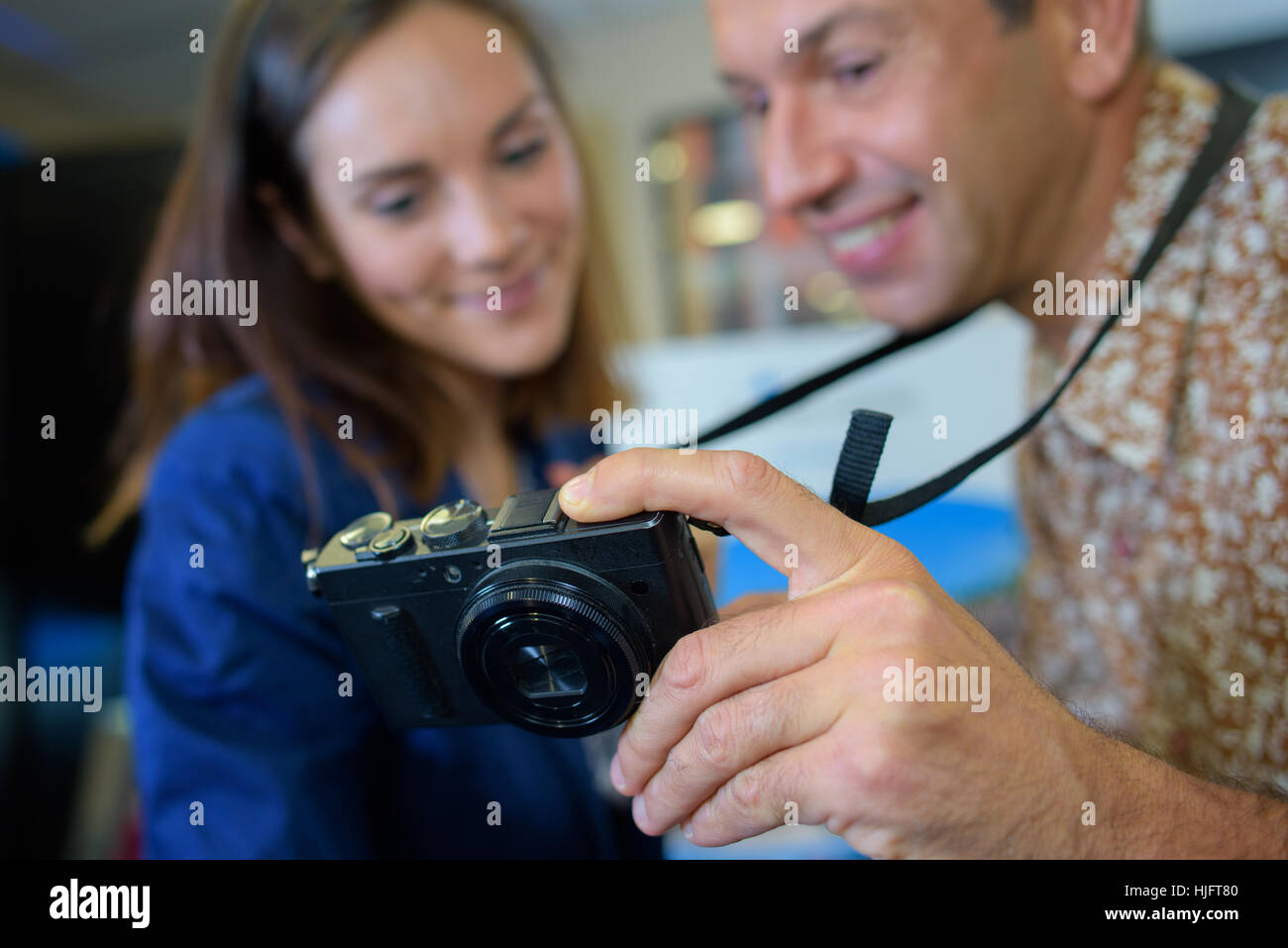 Couple looking at screen of digital camera Stock Photo - Alamy