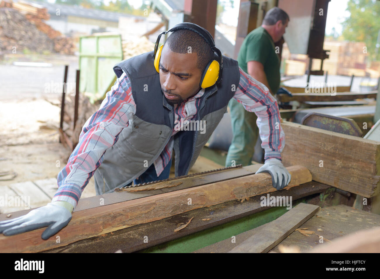 Man working in sawmill Stock Photo - Alamy