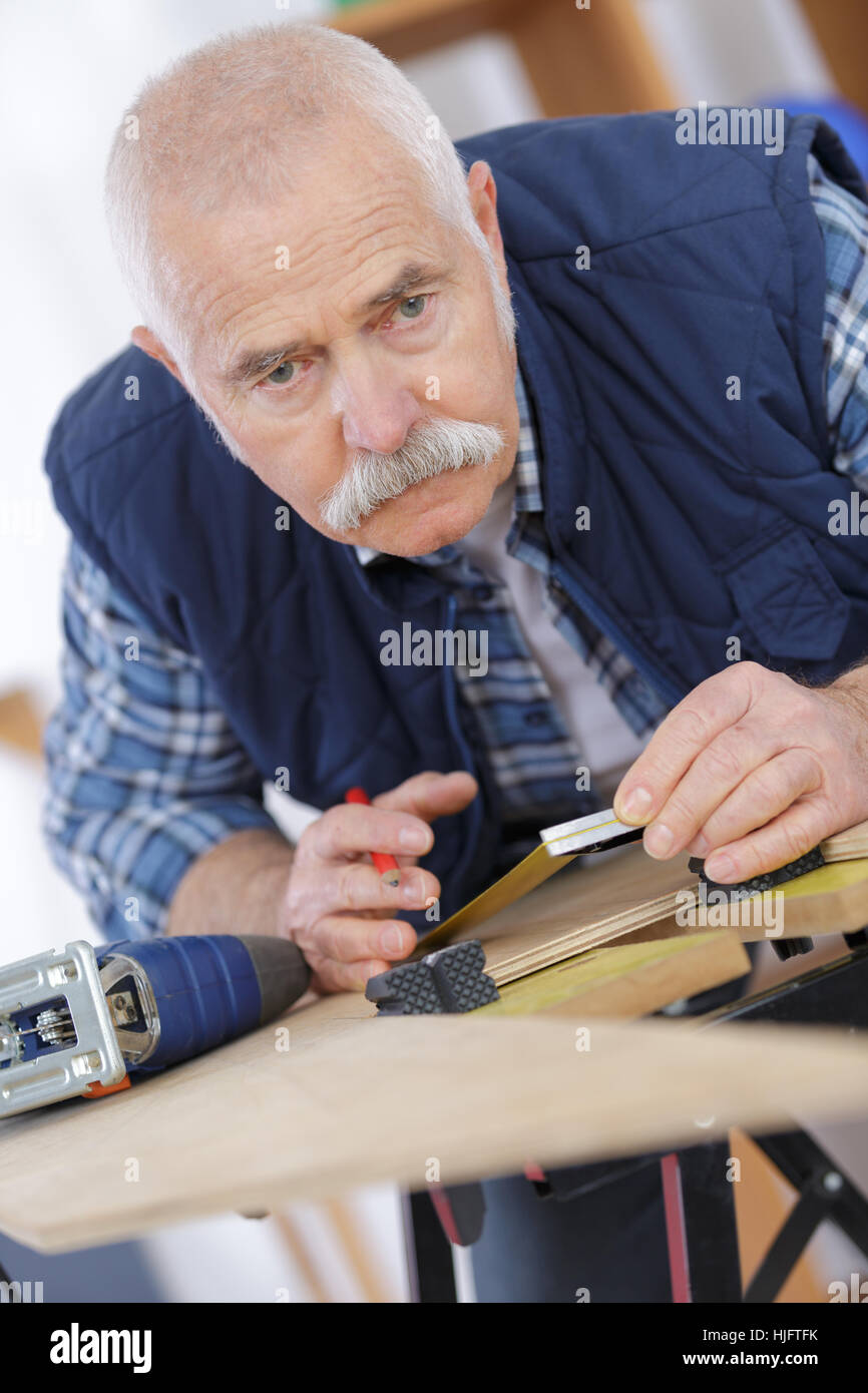 portrait of retired carpenter sitting at his workshop Stock Photo - Alamy