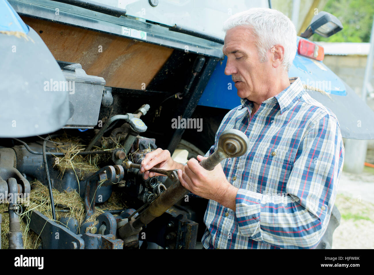 Fixing tractor hi-res stock photography and images - Alamy