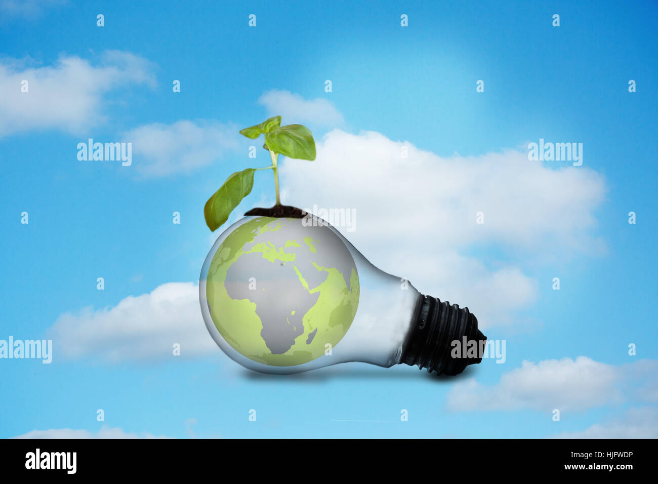 Light bulb with plant and earth against sky background Stock Photo - Alamy