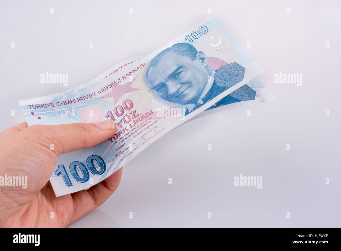 Hand holding 100 Turksh Lira banknotes on white background Stock Photo ...