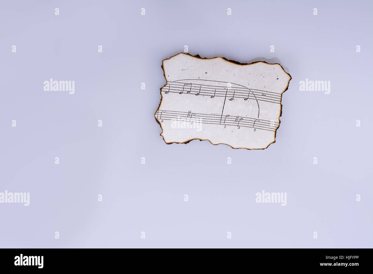Musical notes on a burnt paper on a white background Stock Photo - Alamy