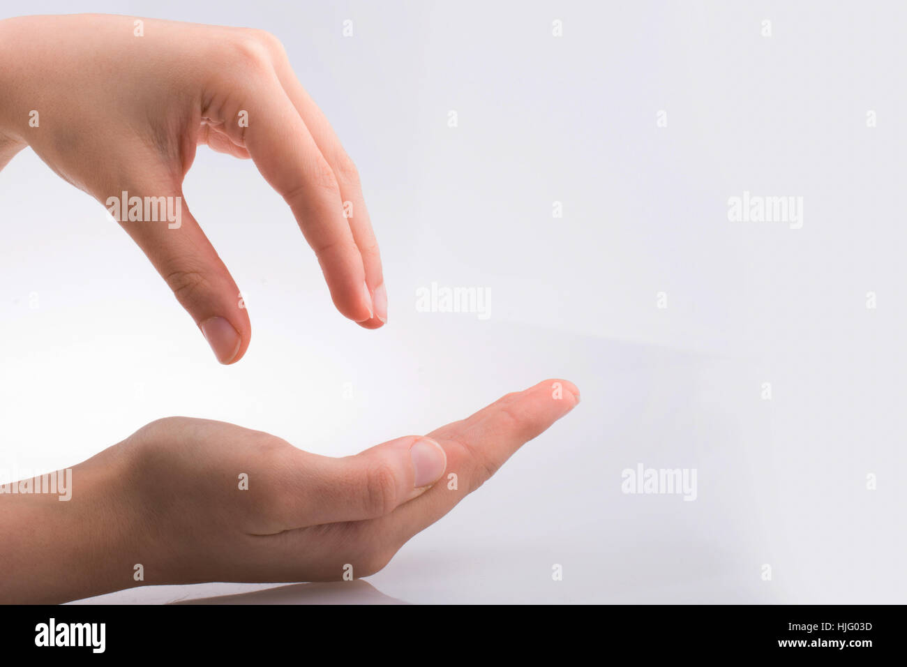 Hand holding gesture made on a white background Stock Photo - Alamy