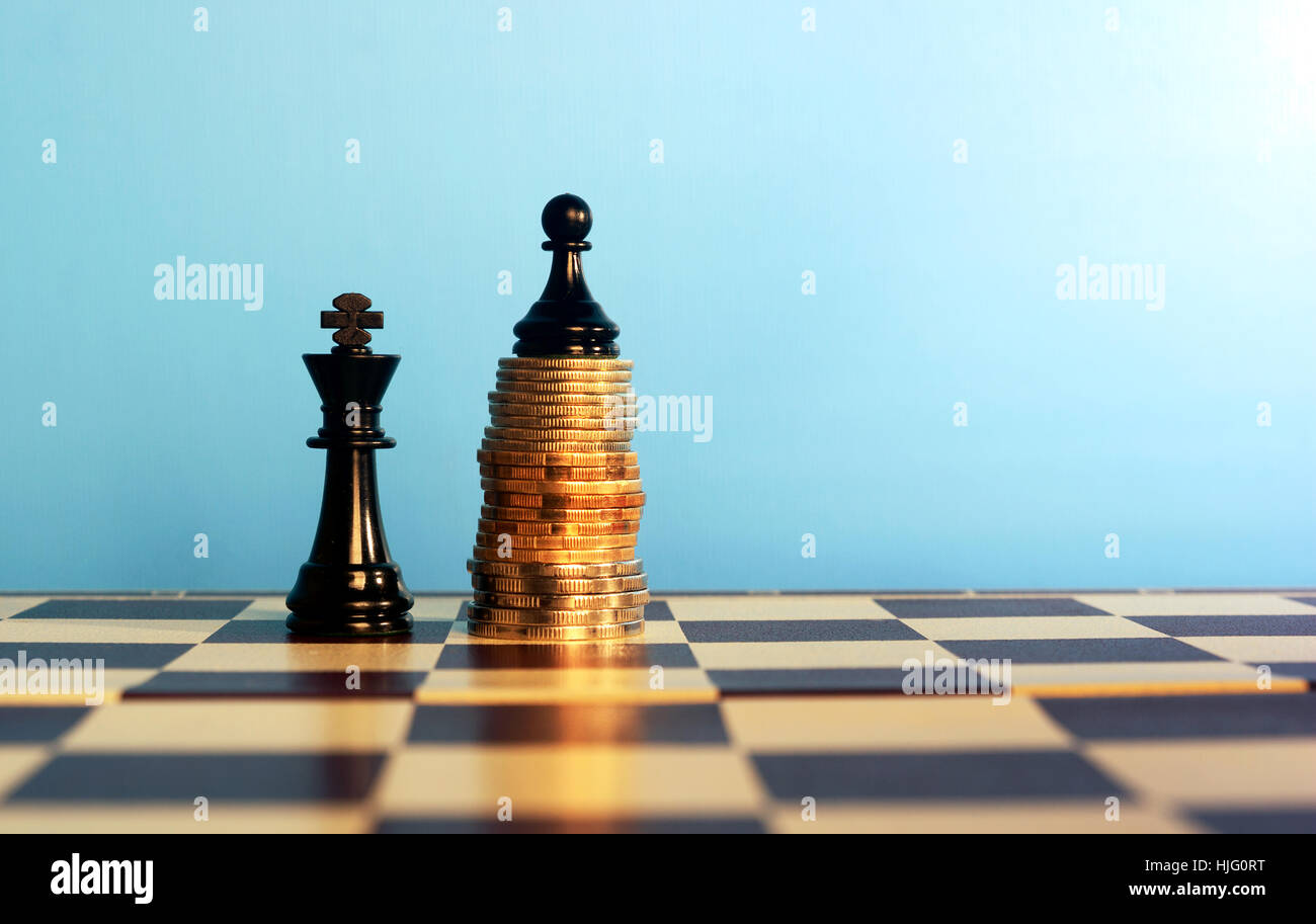 power of the money concept. Chess pawn standing on the money over the ...