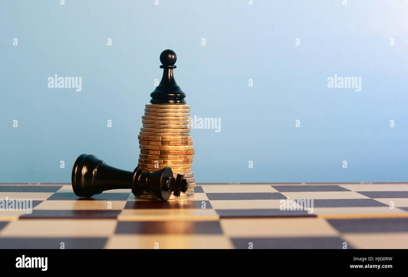 power of the money concept. Chess pawn standing on the money winning ...