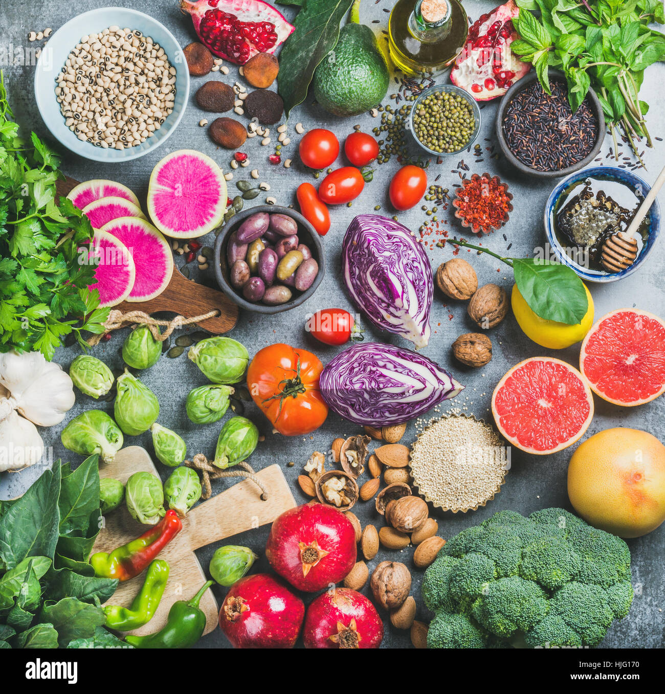Healthy raw food variety over grey concrete background Stock Photo - Alamy