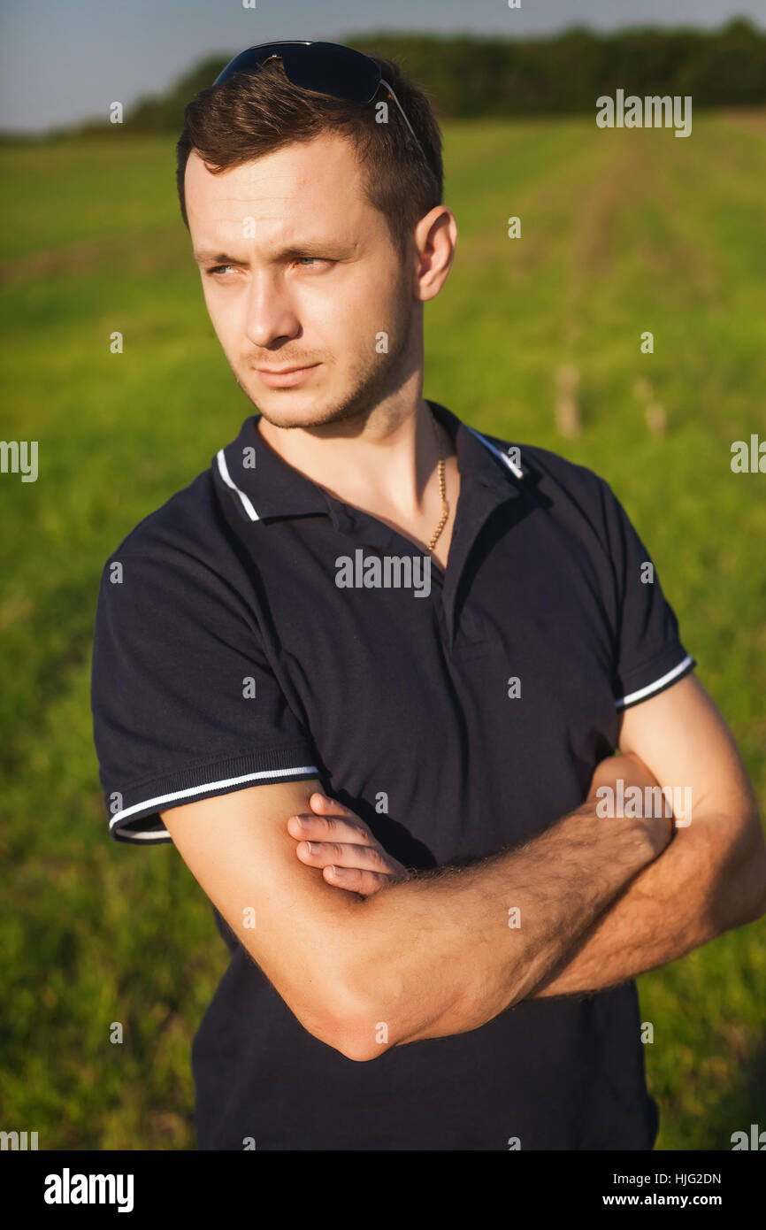 man standing in a field on the green grass and looks forward Stock ...