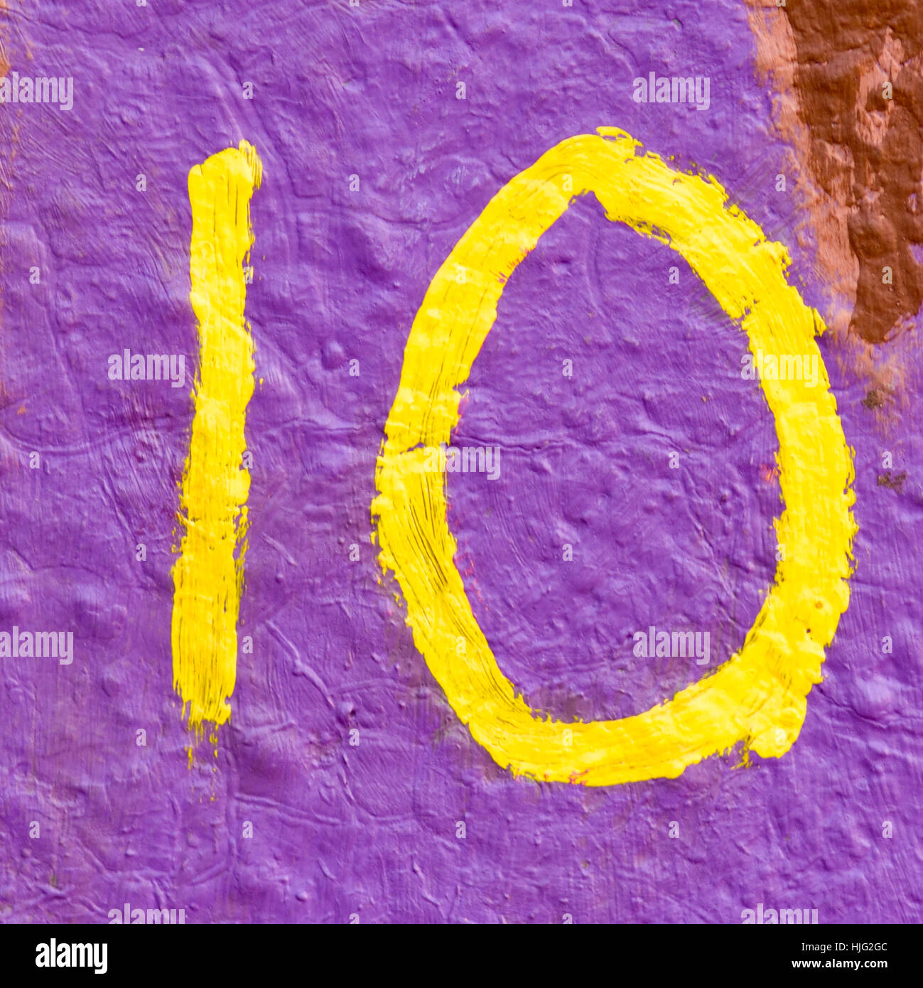 House number 10 painted sign in yellow with purple background Stock ...