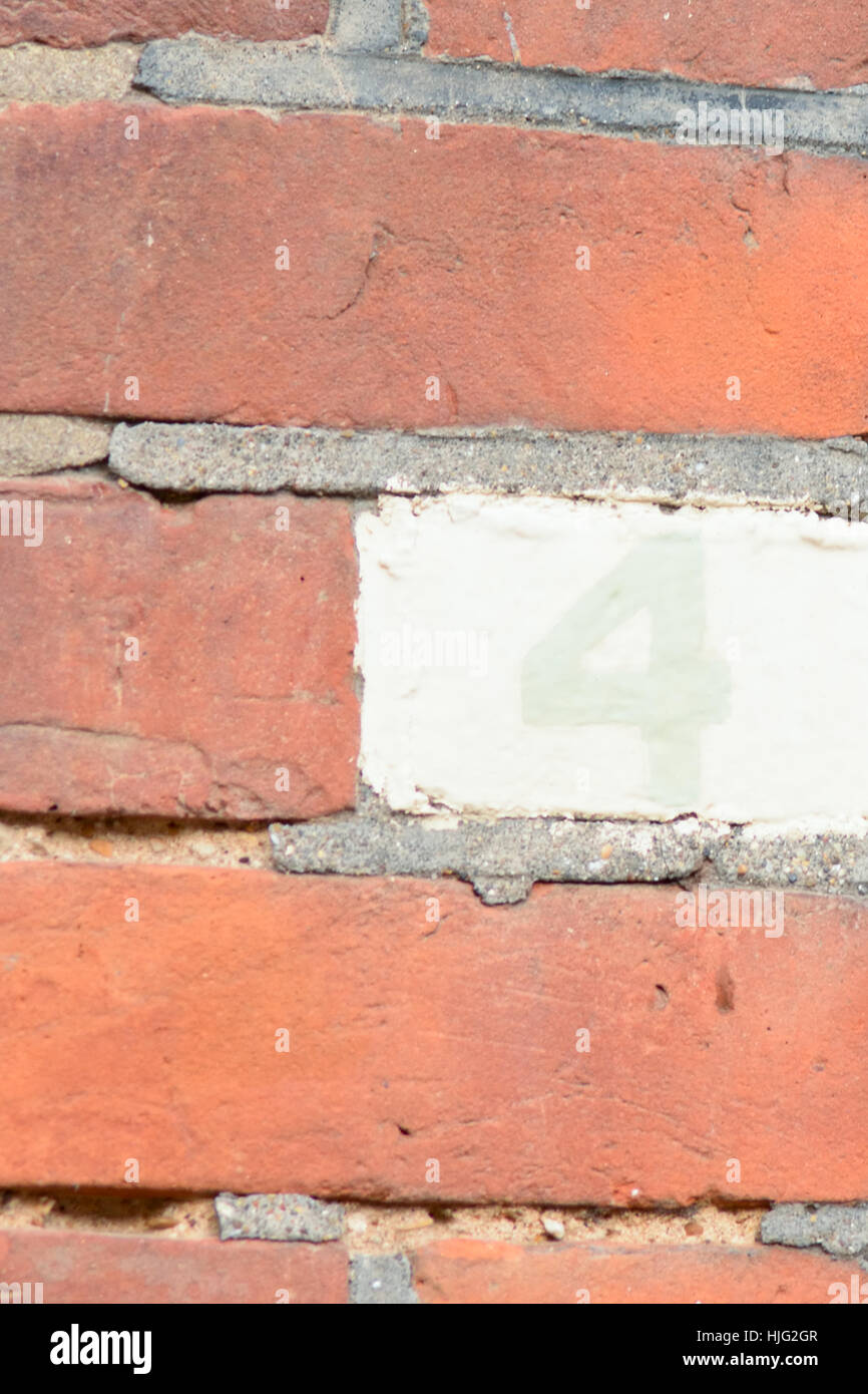 Faded house number 4 painted sign on wall Stock Photo - Alamy