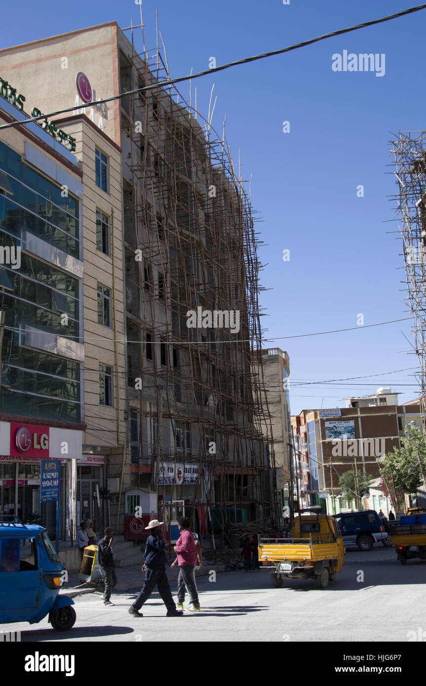 Tree branches scaffolding covering the face of a building in Mekelle ...