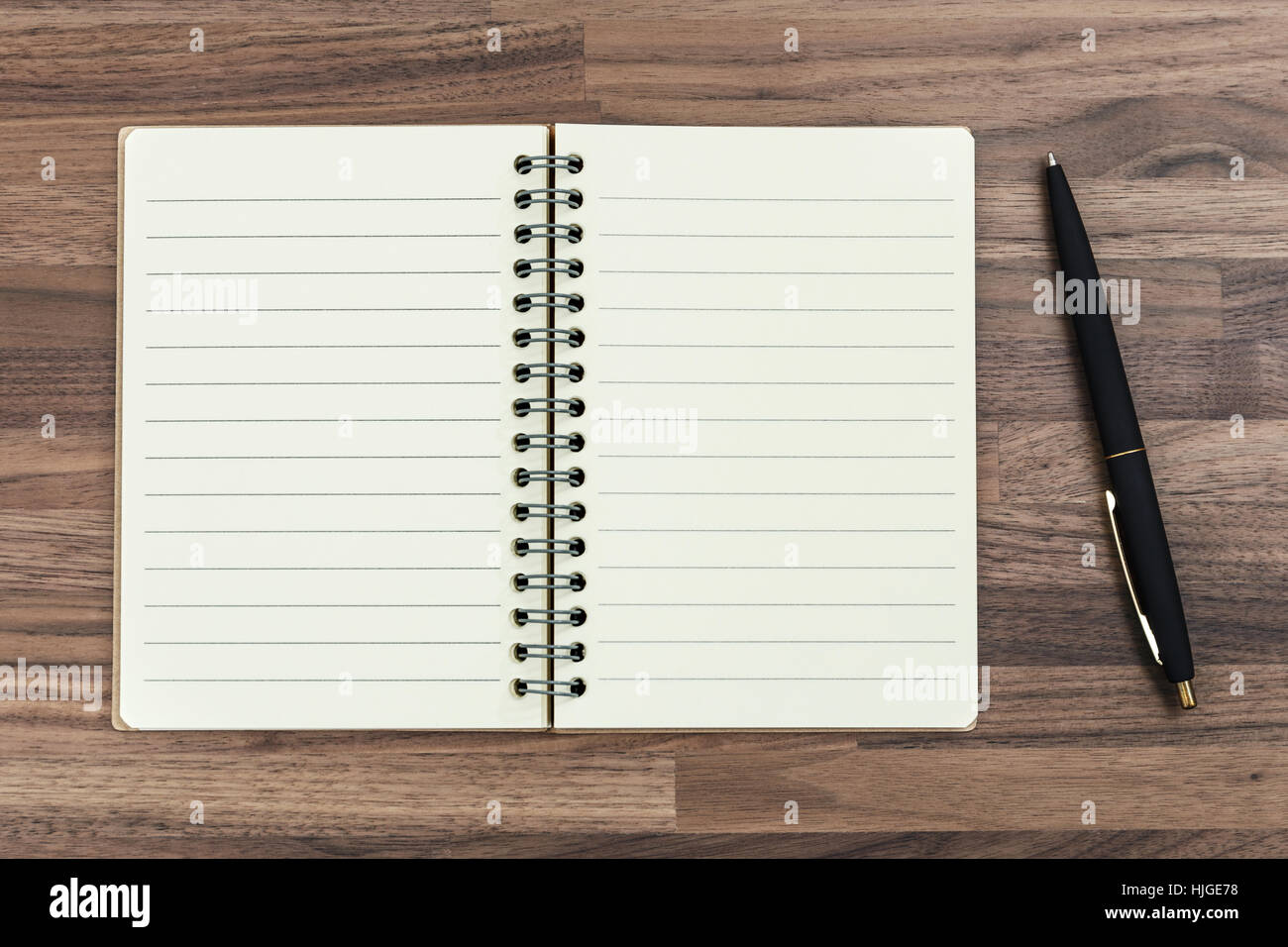 Notebook on office wood desk with pen Stock Photo - Alamy