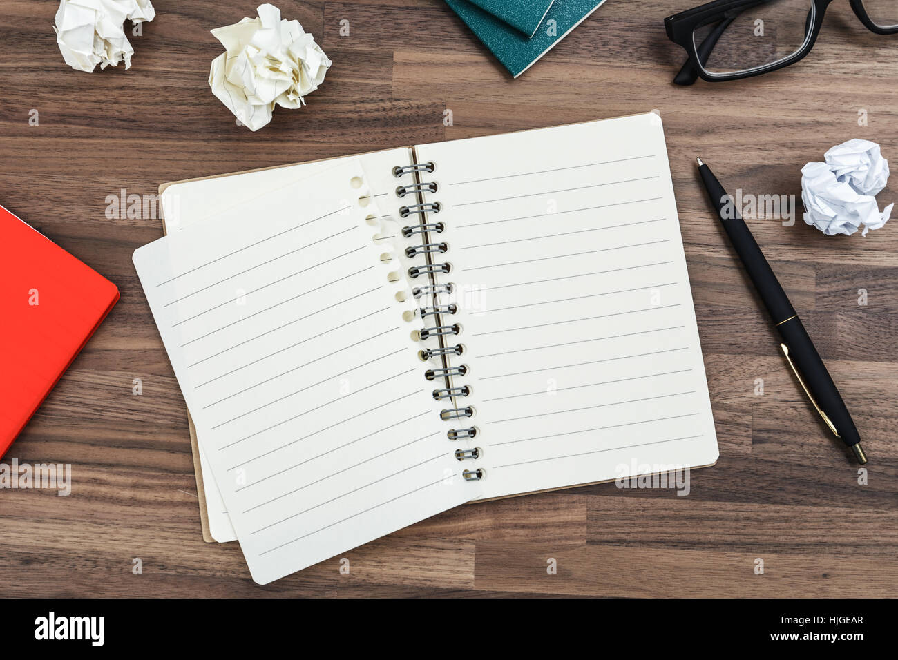 Notebook on office wood desk with pen and crumpled paper ball Stock ...
