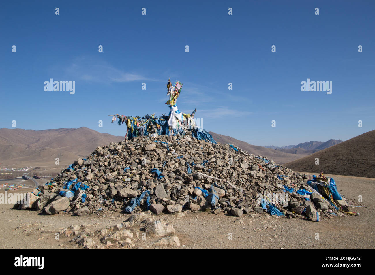 An ovoo made from stones placed by worshipers with a scarf covered ...
