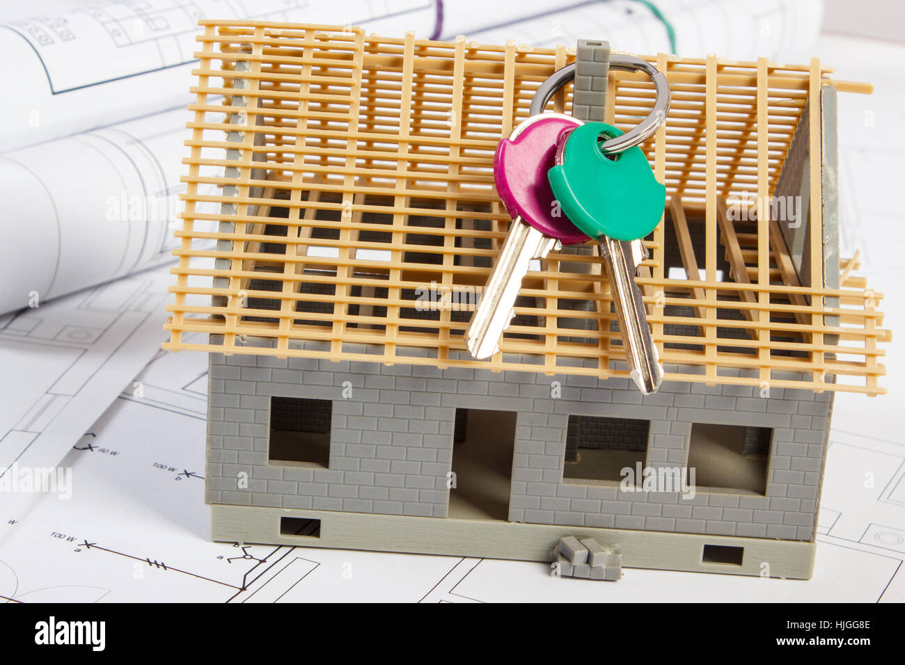 Home keys and small house under construction lying on electrical ...