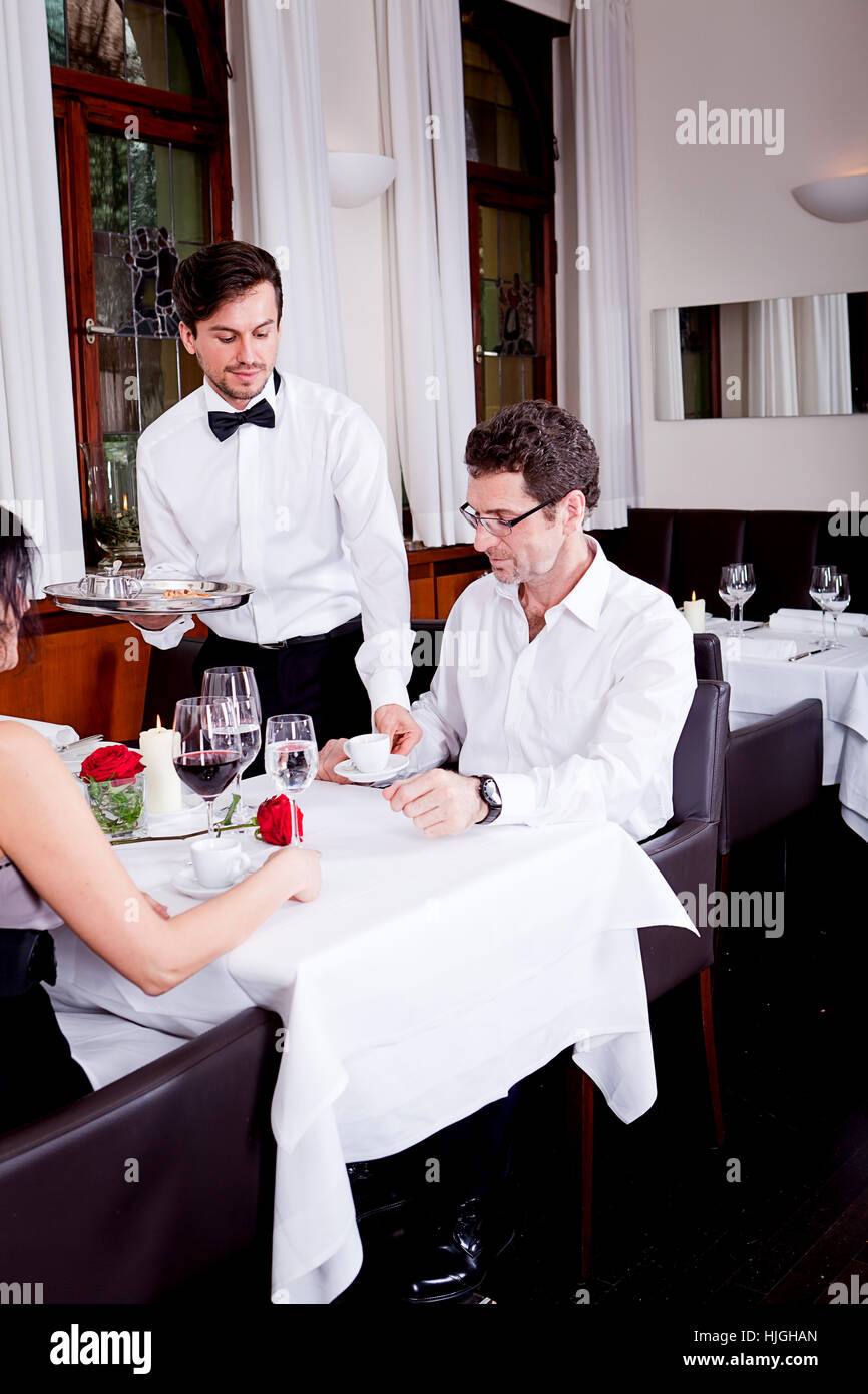 waiter serving a young couple after-dinner coffee Stock Photo - Alamy