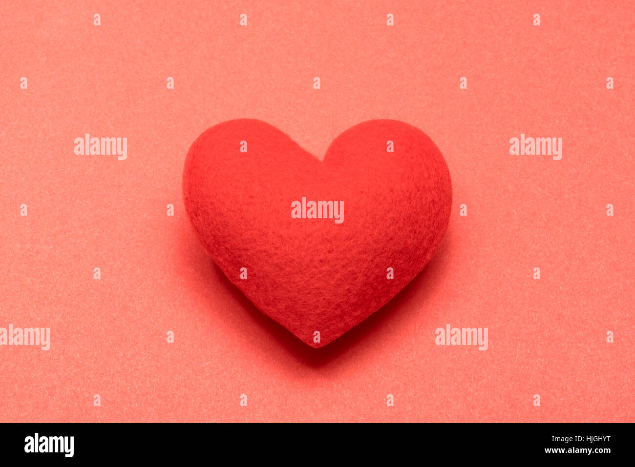 Single red heart on pink background. Symbol of love Stock Photo - Alamy