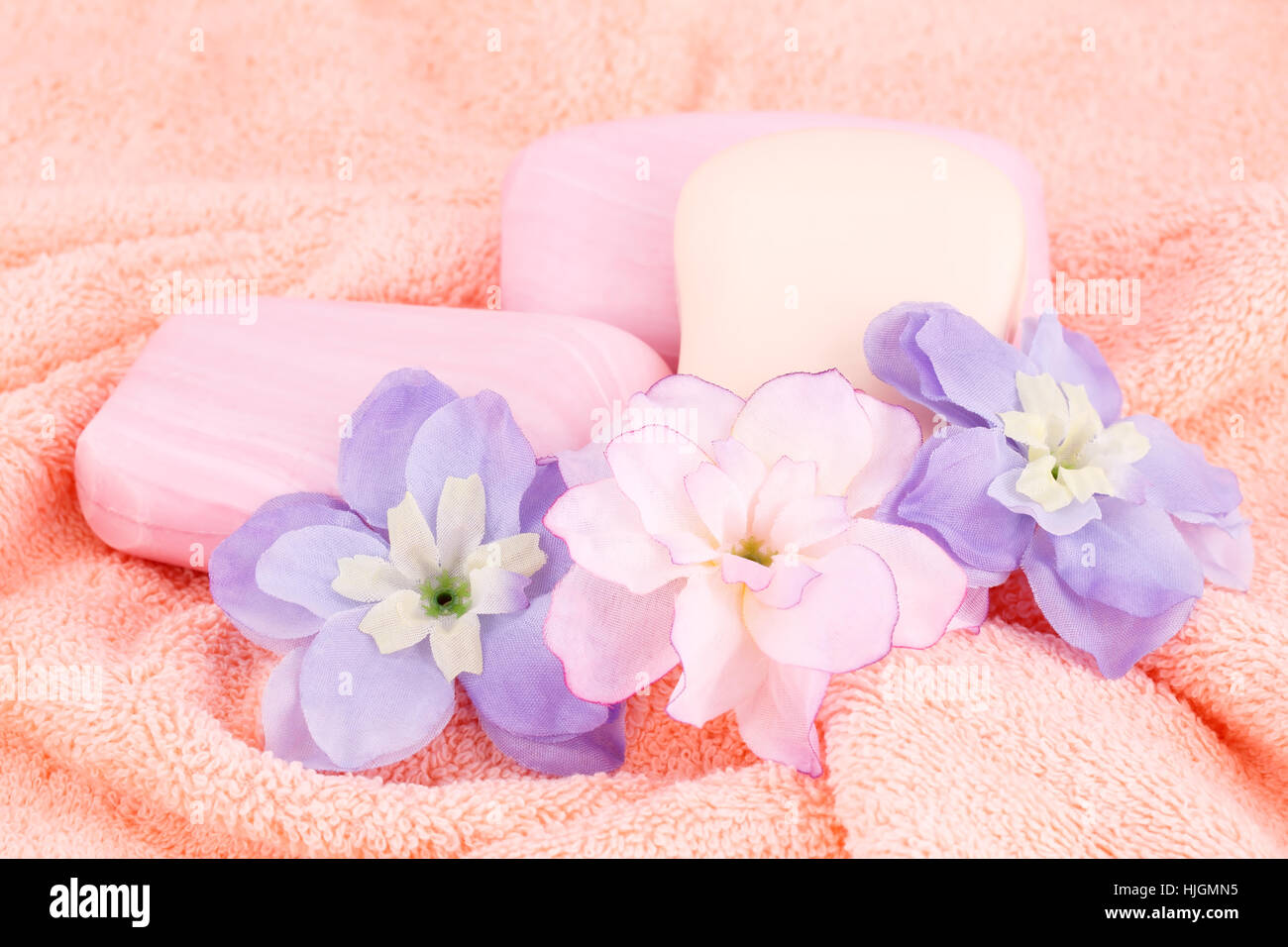 Colorful soaps and flowers on towel Stock Photo - Alamy