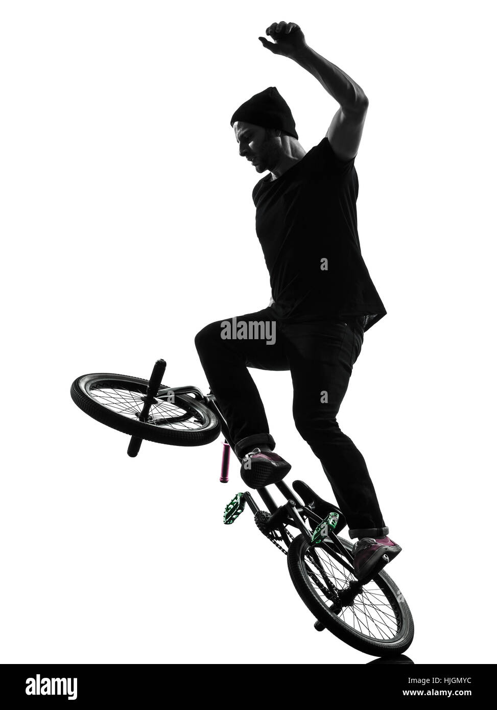 one caucasian man exercising bmx acrobatic figure in silhouette studio ...