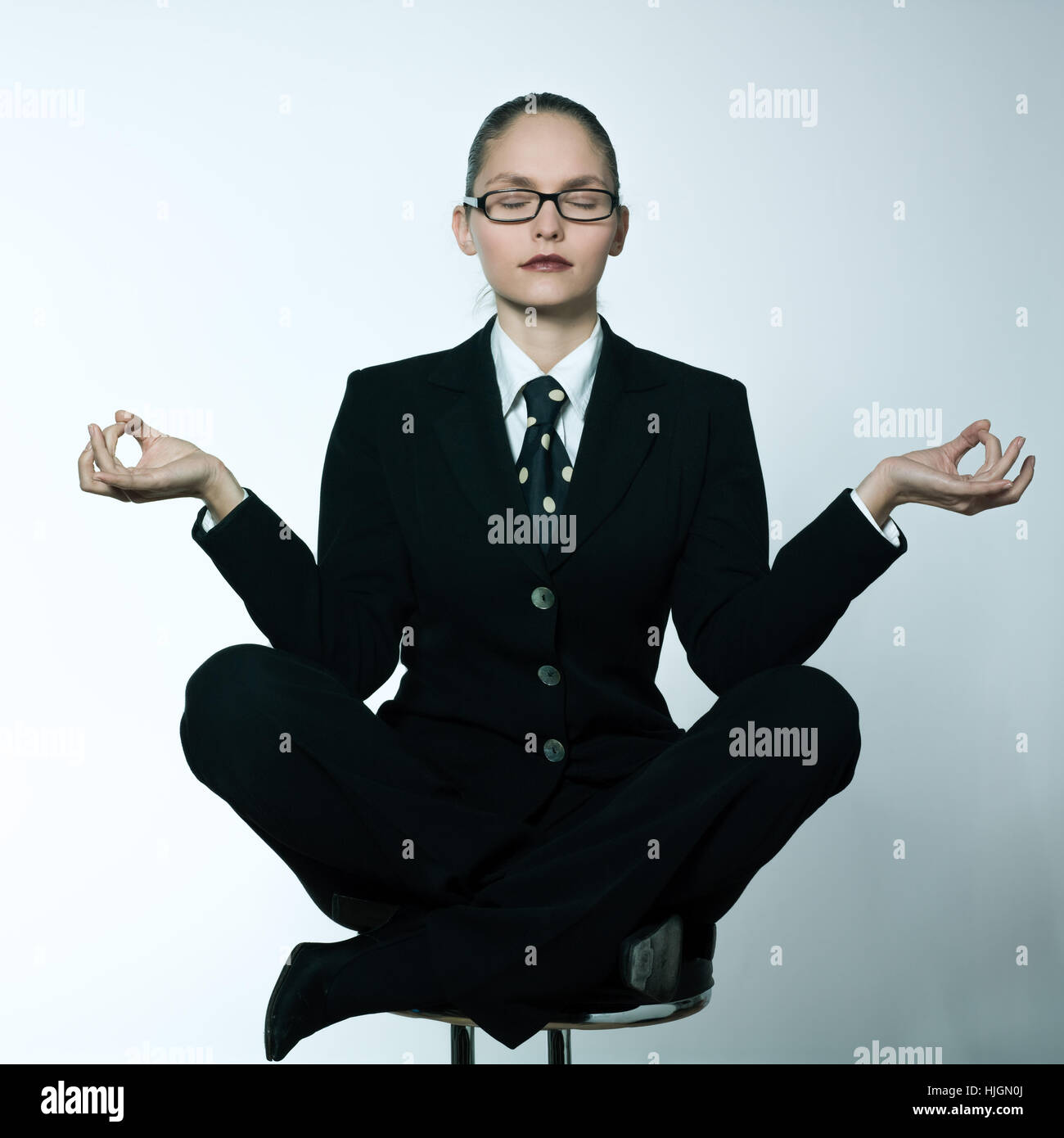 studio shot portrait of one caucasian young woman sitting on the lotus ...