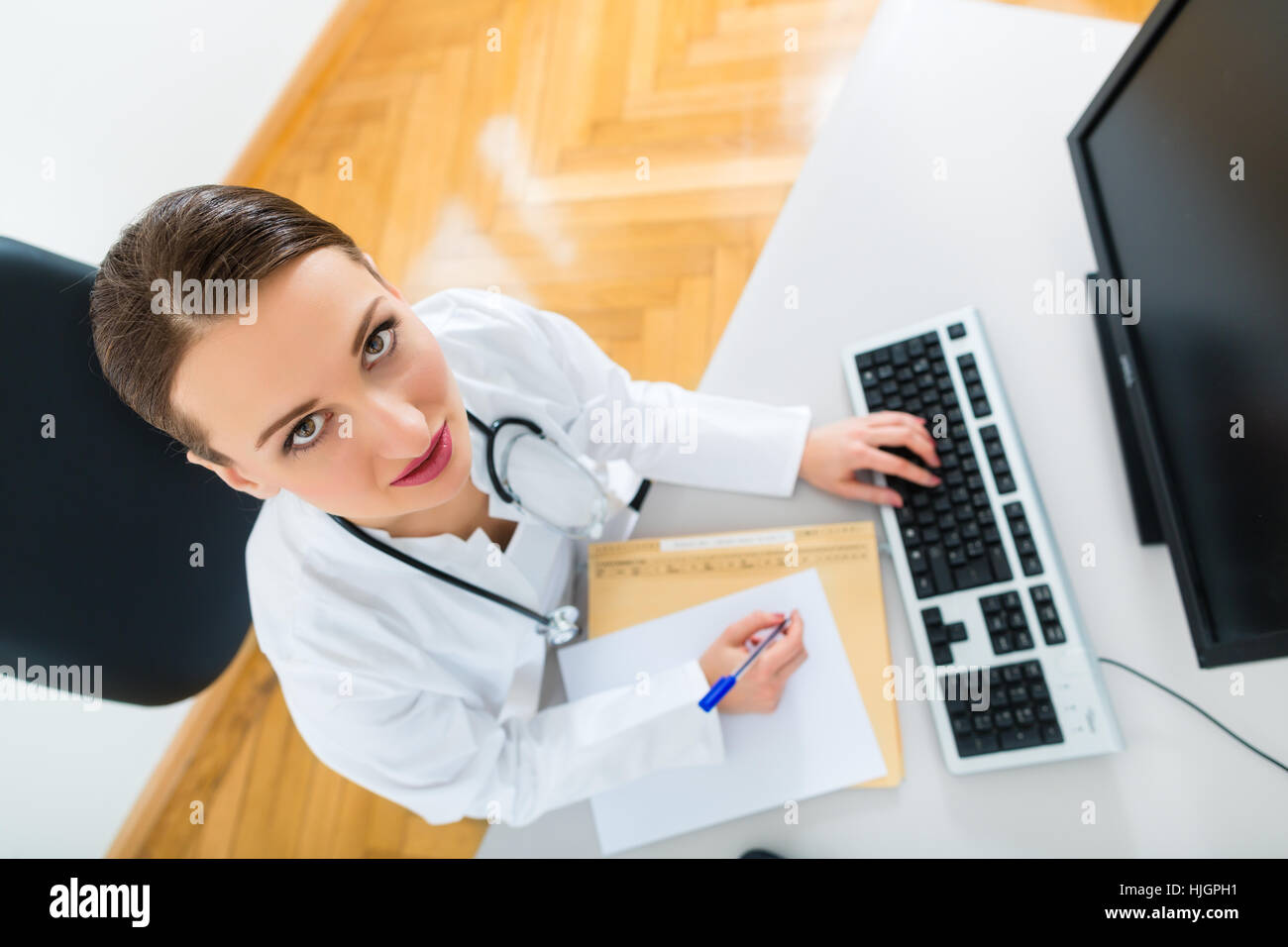 physicians in practice writing in a medical record Stock Photo - Alamy
