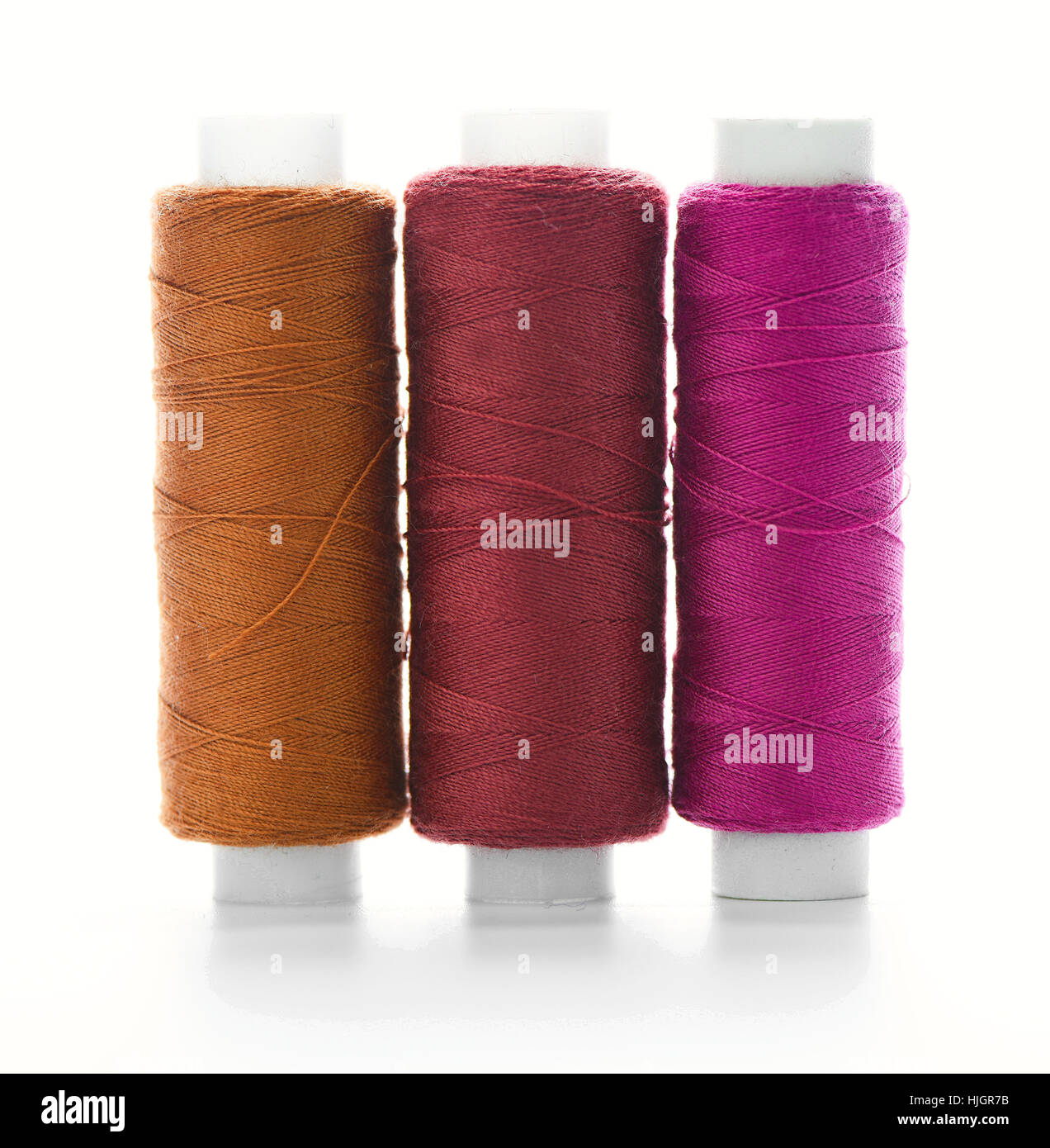 Colorful spools of thread on a white background Stock Photo - Alamy