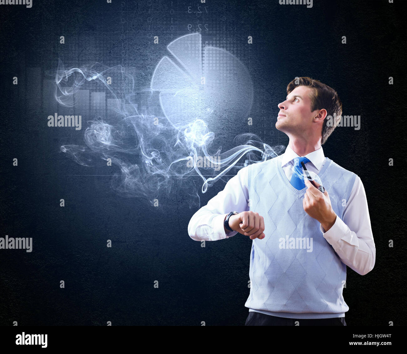 Young businessman smoking pipe with diagrams and graphs at background ...