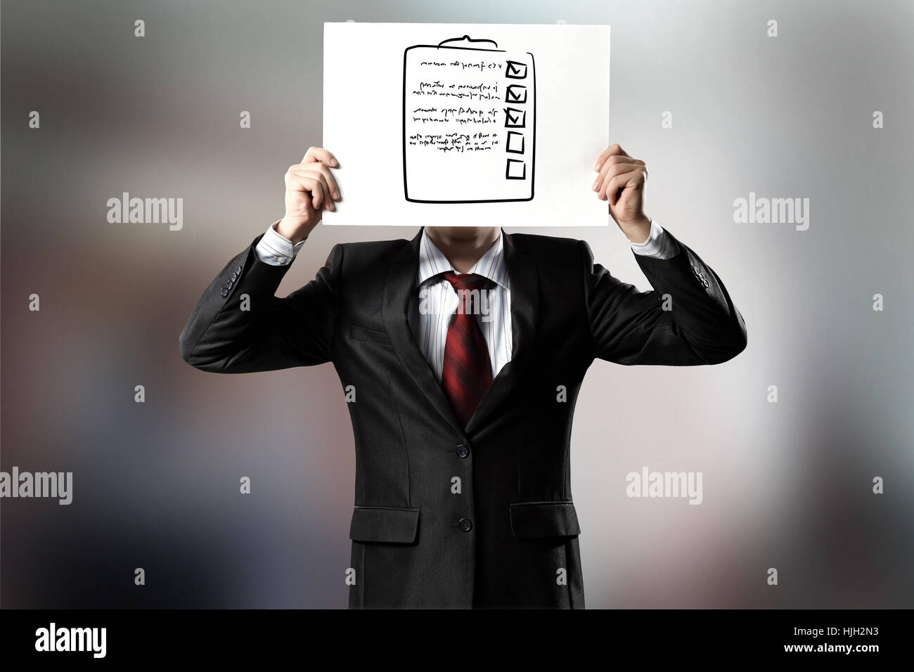 Businessman hiding his face behind paper with drawing Stock Photo - Alamy