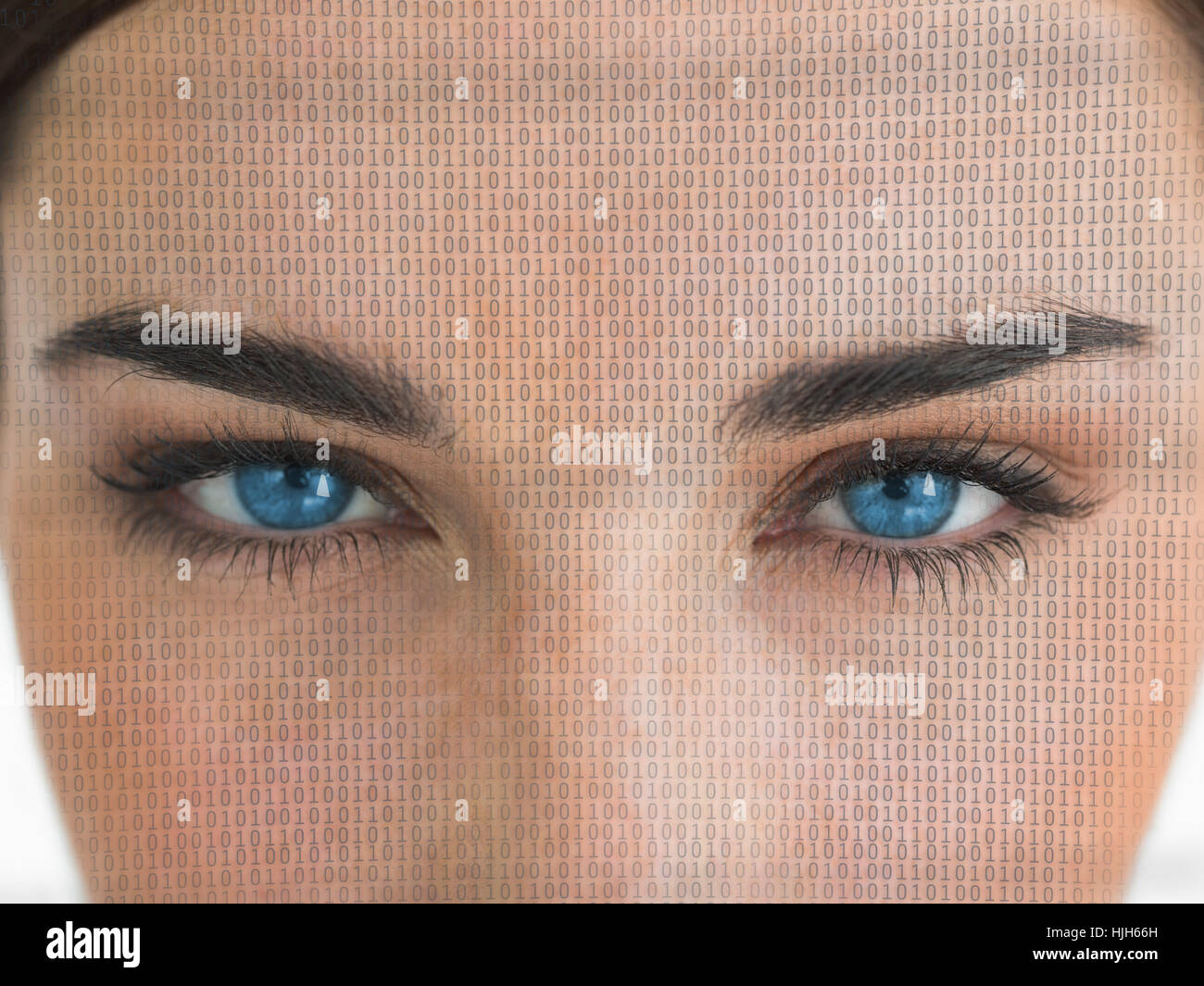 Attractive blue eyed woman with binary coding on face close up staring ...
