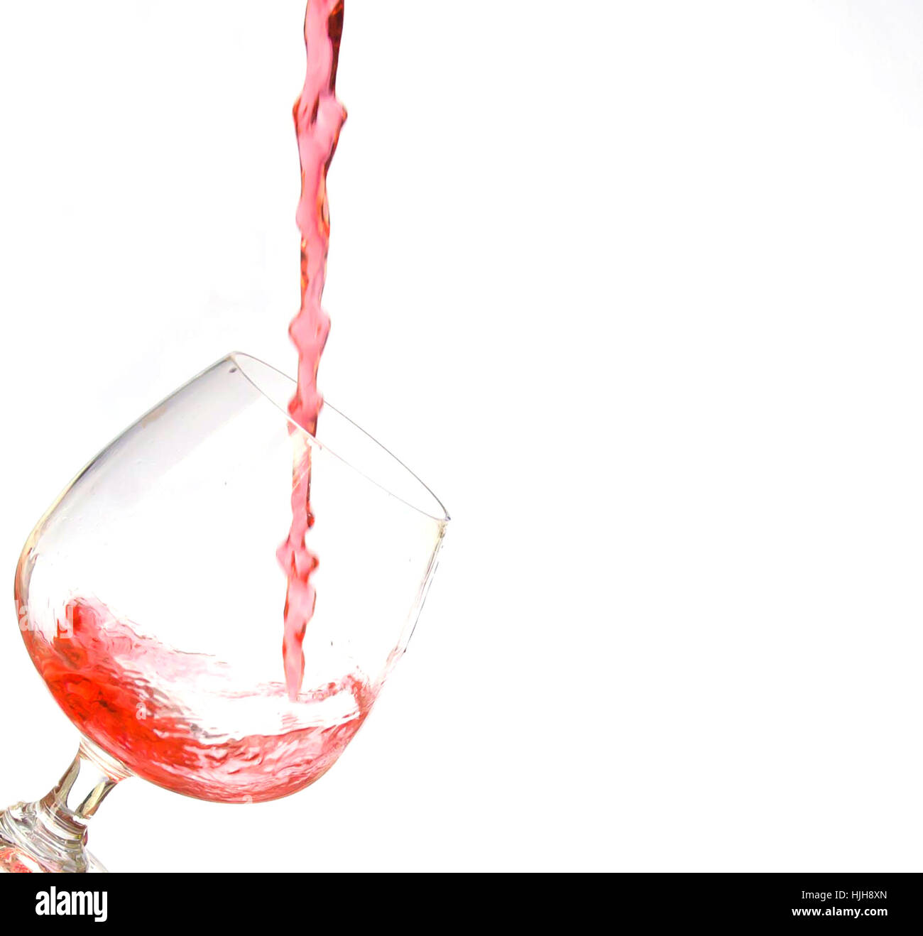 pour into glass close-up isolated over white background Stock Photo - Alamy