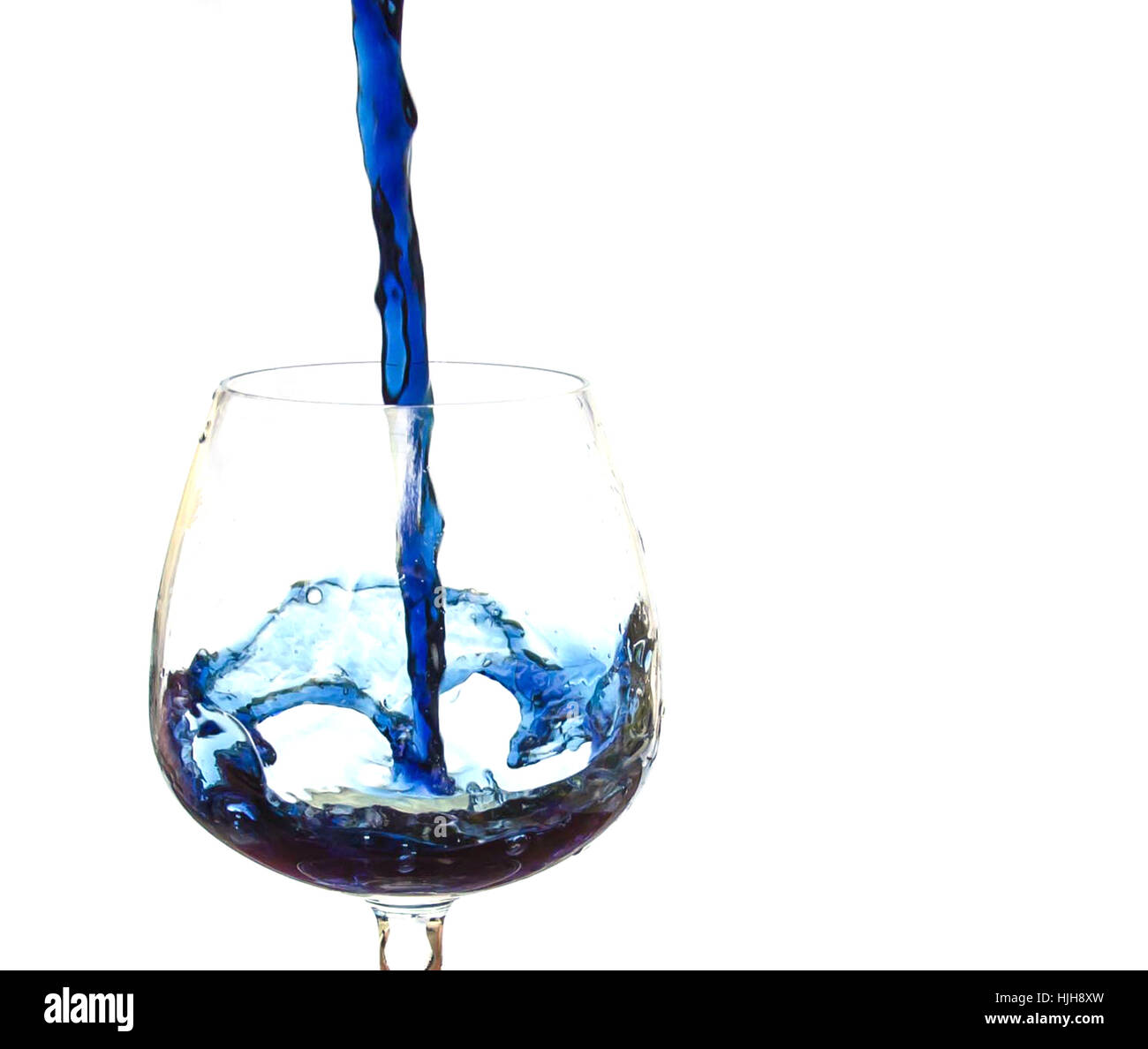 pour into glass close-up isolated over white background Stock Photo - Alamy