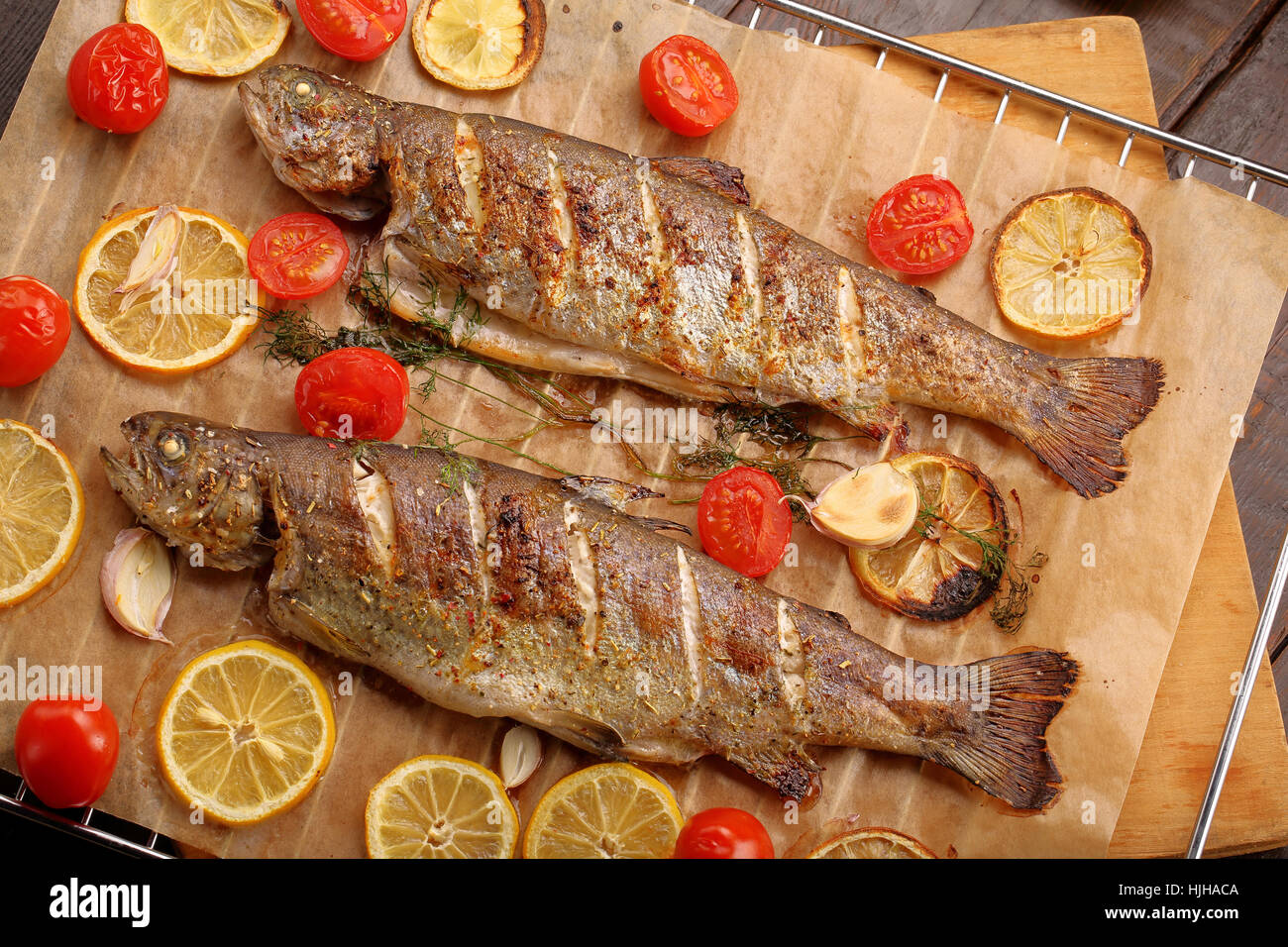 Whole baked fish on the grill Stock Photo - Alamy