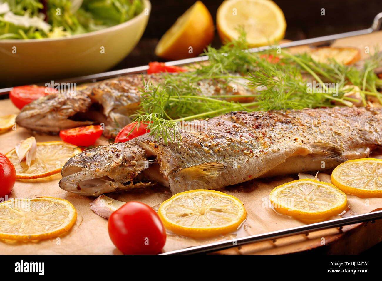 Whole baked fish on the grill Stock Photo - Alamy