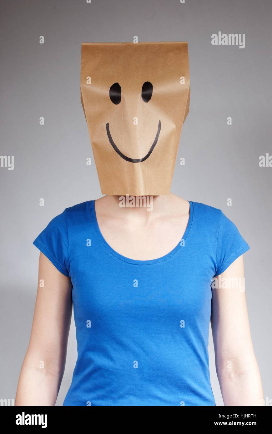 a person with a happy looking paper bag on its head Stock Photo - Alamy