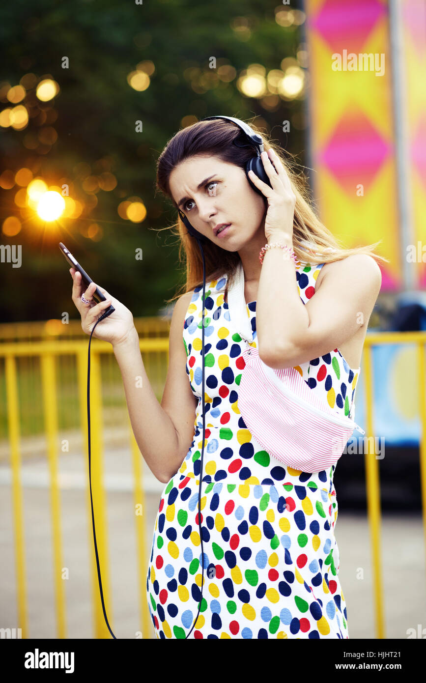 Young beautiful girl listening player on the street Stock Photo - Alamy