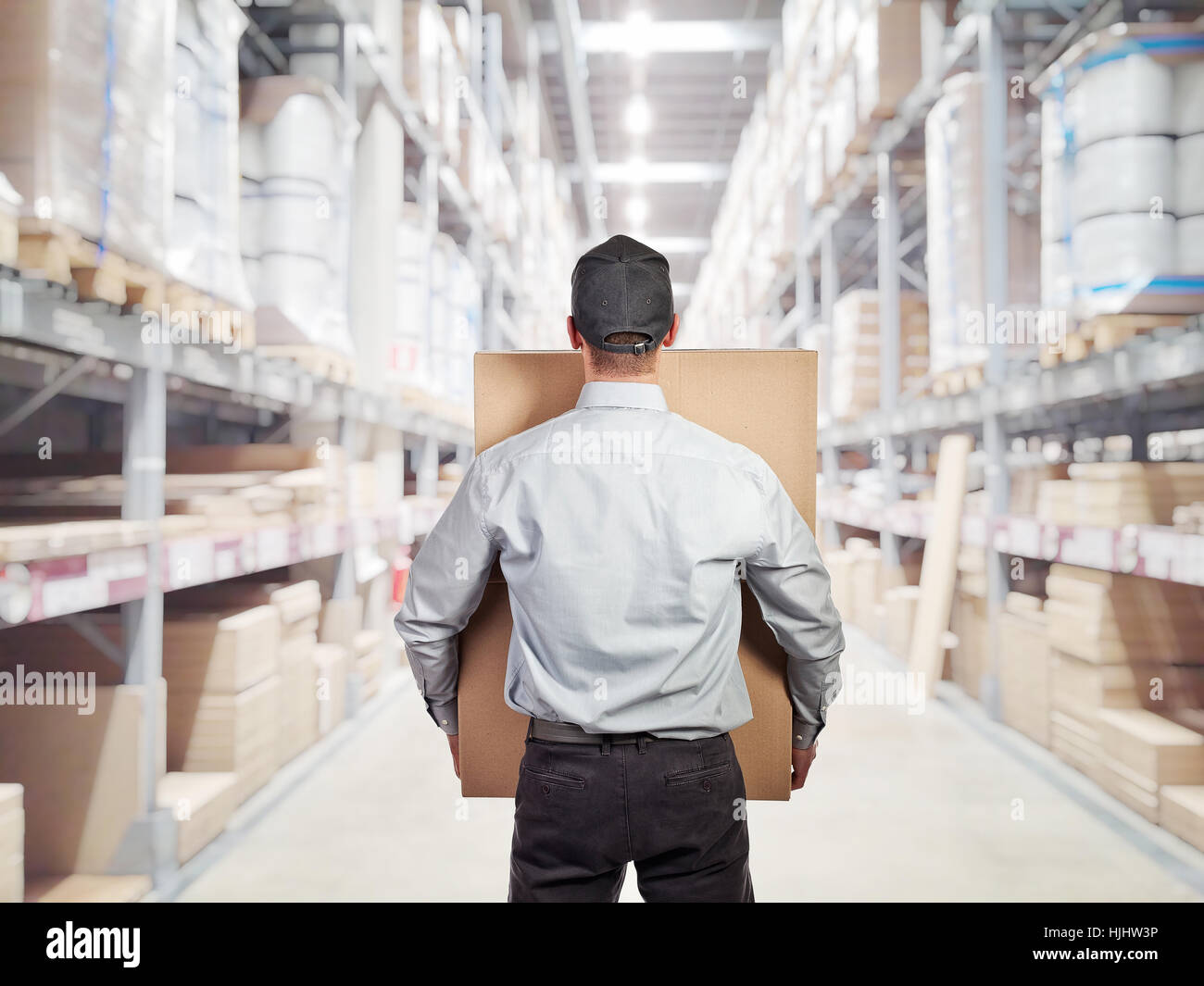 caucasian delivery man in warehouse Stock Photo - Alamy
