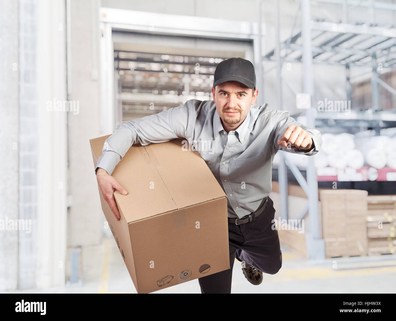 caucasian delivery man in warehouse Stock Photo - Alamy