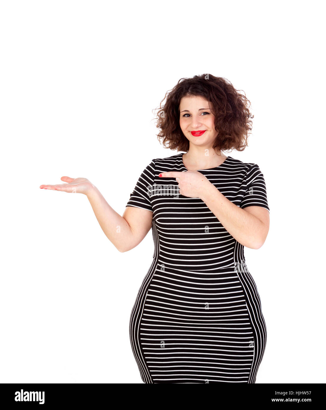 Beautiful curvy girl with striped dress indicating something with the ...