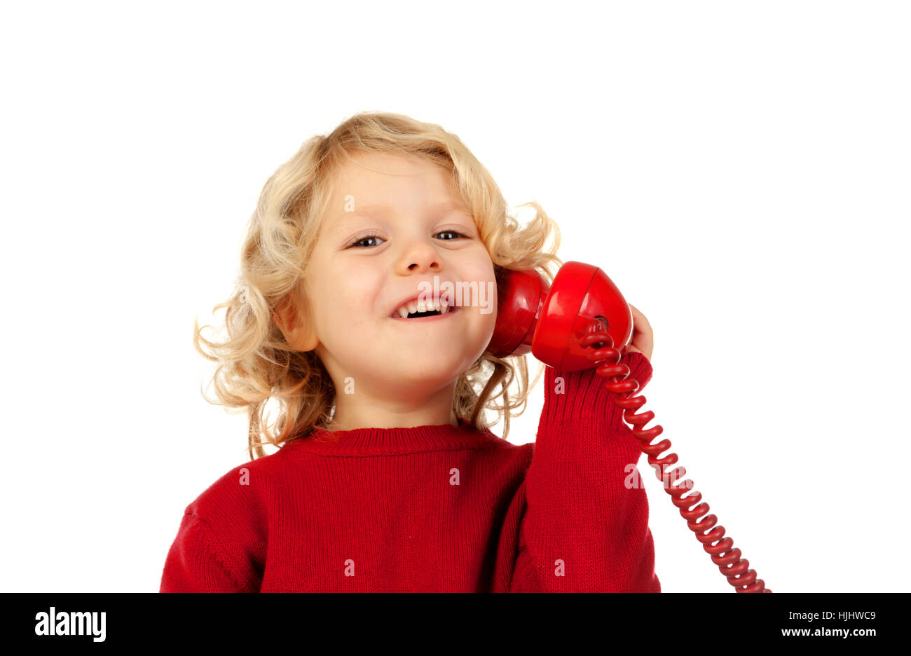 Funny little child talking on the phone isolated on a white background ...