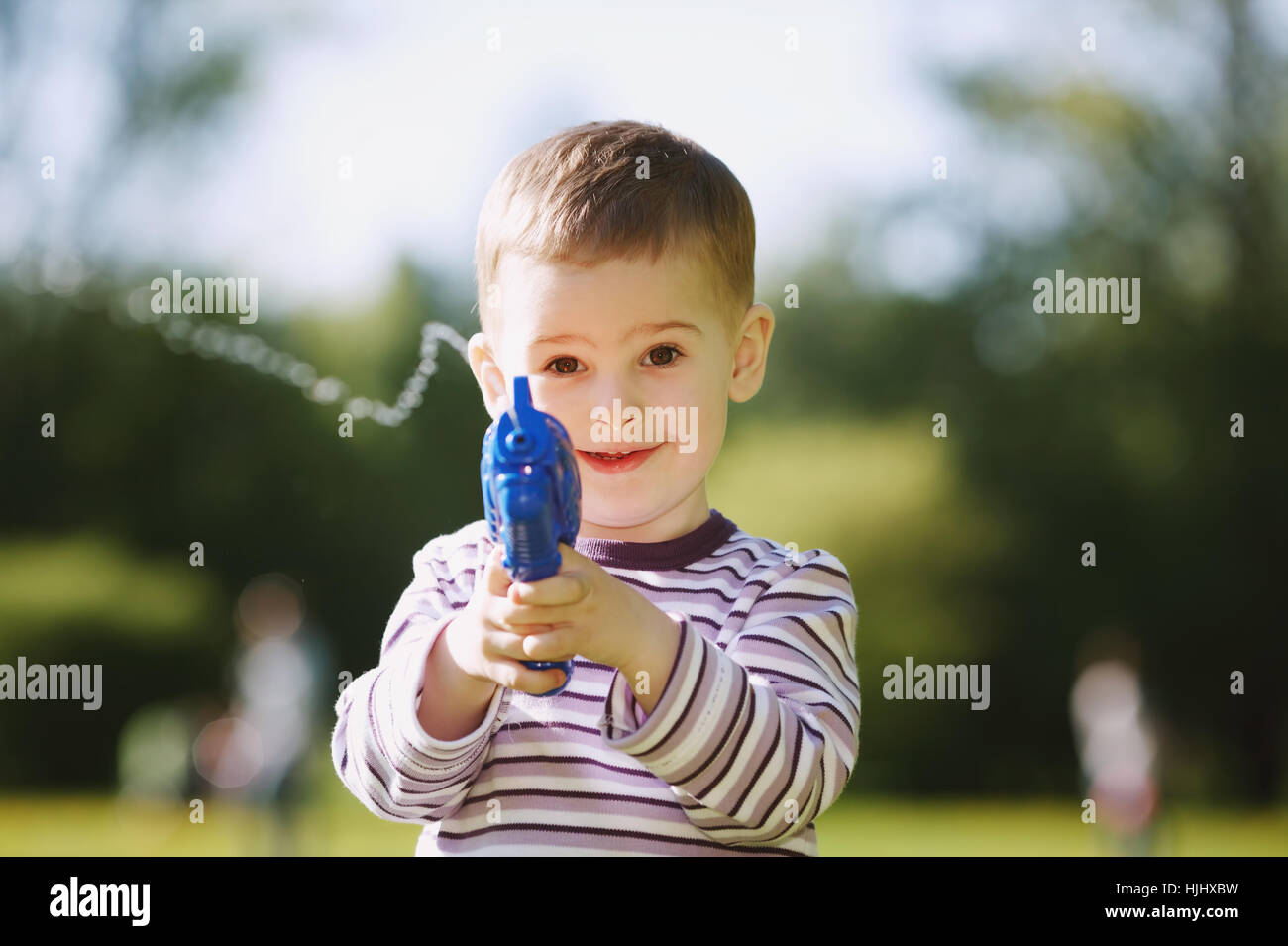 little boy with water gun Stock Photo - Alamy