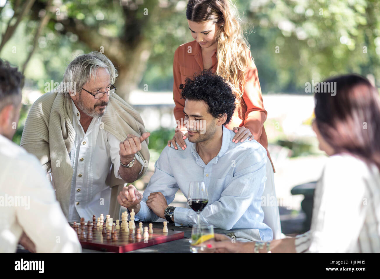 People gathering around chess board Stock Photo - Alamy