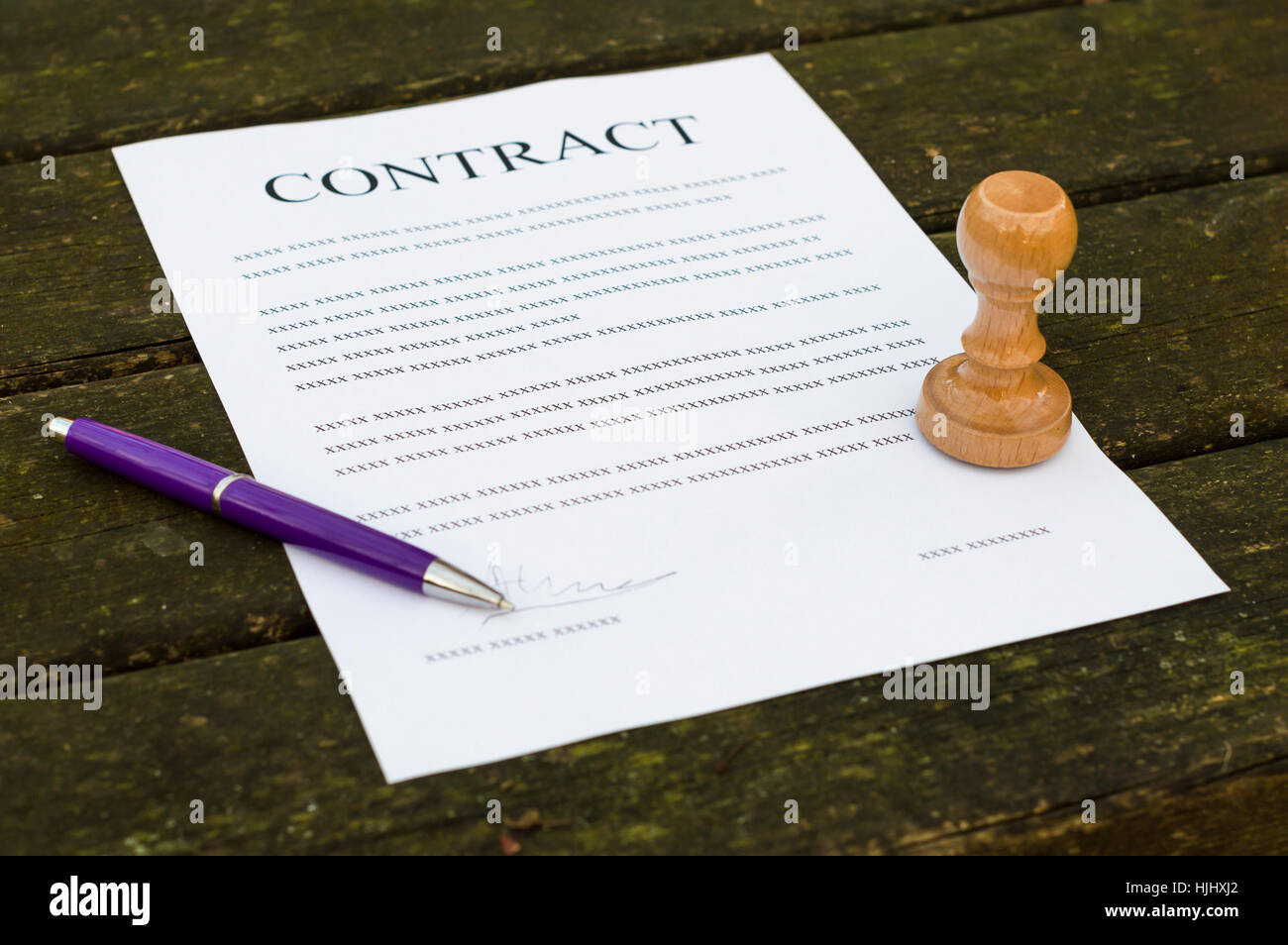 Pen and stamp on a filled contract Stock Photo - Alamy