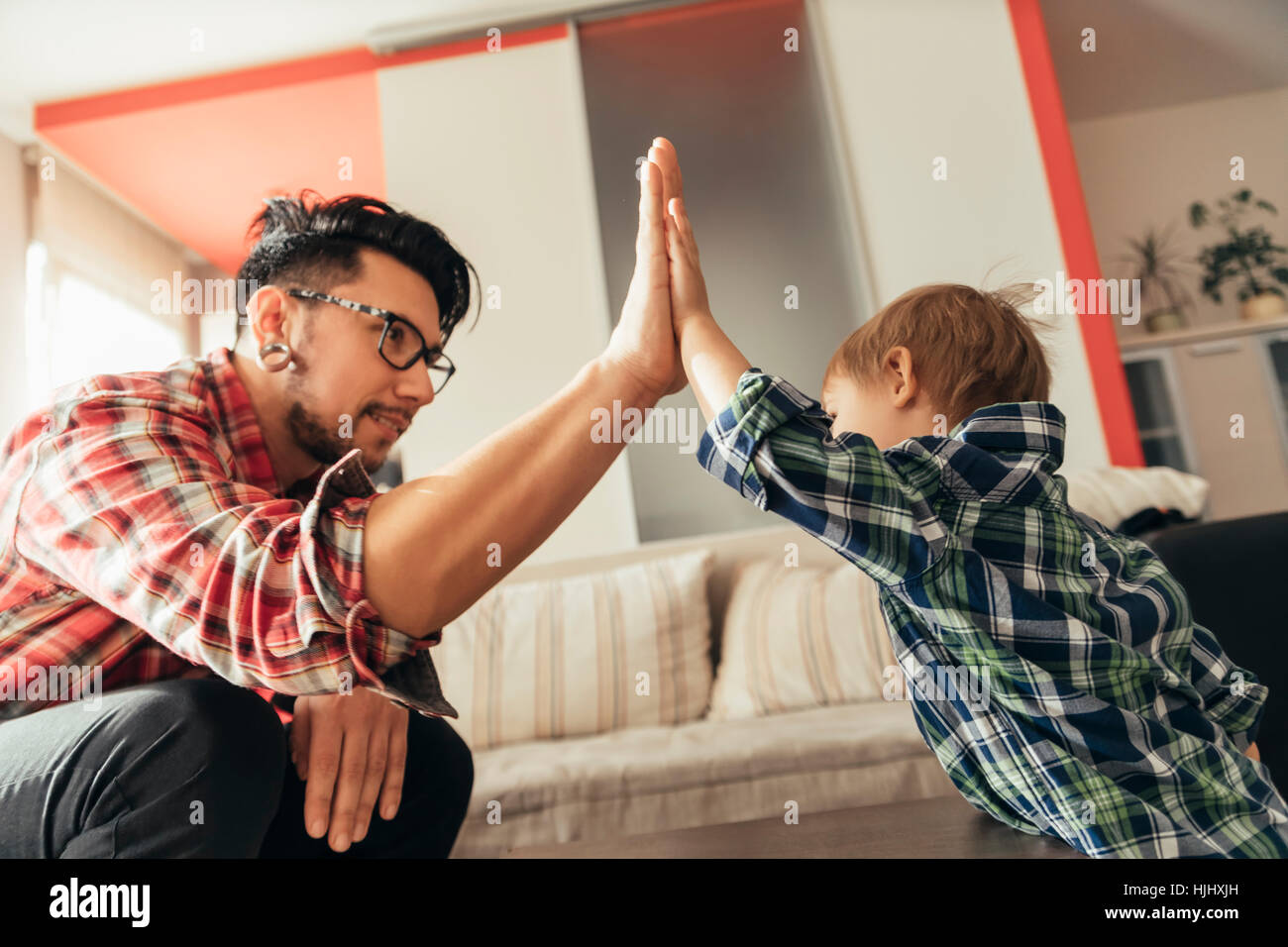 Father and son high fiving Stock Photo - Alamy